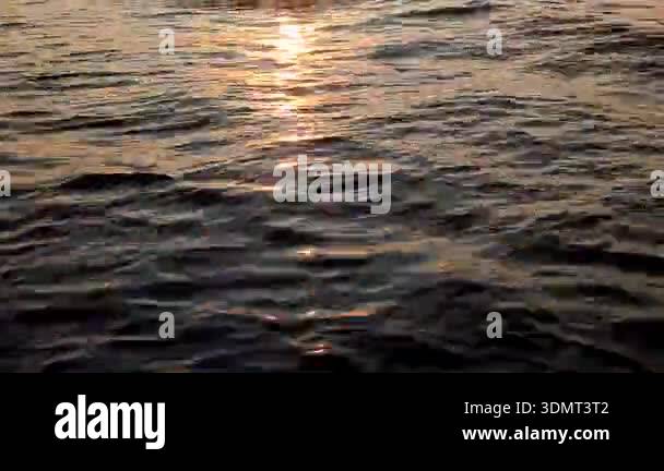 The surface of the sea waves with a sun path in the morning at sunrise ...
