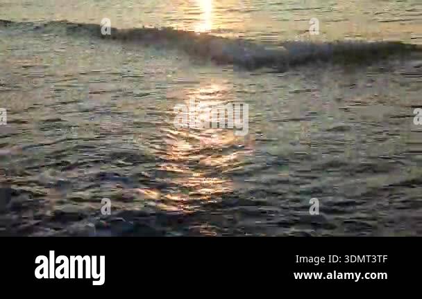 The surface of the sea waves with a sun path in the morning at sunrise ...