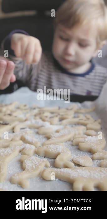 Family making cookies - Little boy helps mom decorate cookies with ...