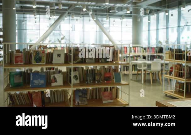 Library bookshelves and study tables in soft defocused bokeh with ...