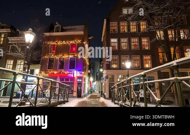 Night scene showing snowfall in the red light district of Amsterdam ...