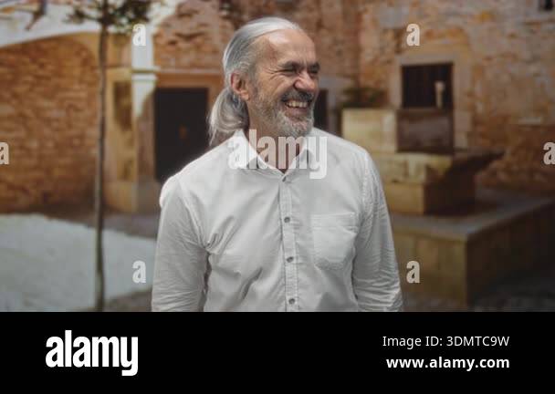 Man with hoary long hair and beard laughing with head tilted back, face ...