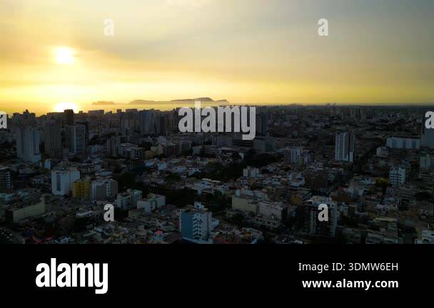 Aerial drone footage of golden sunset over Lima, Peru with Pacific ...