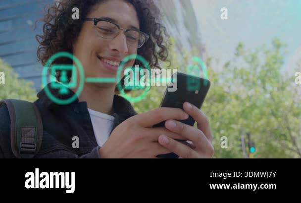 Male user tapping smartphone on sidewalk and showing floating icons ...