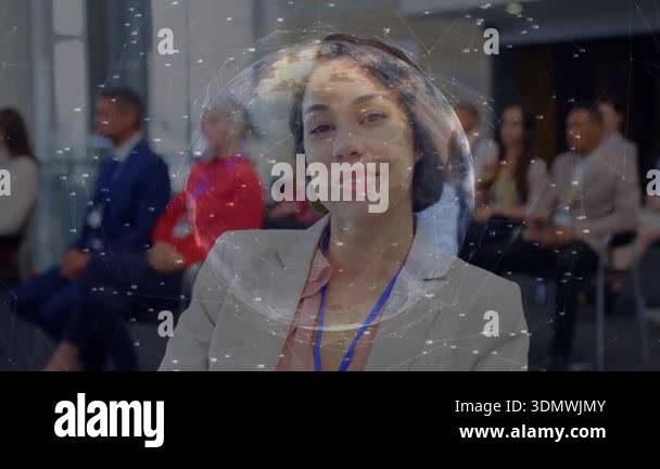 Conference attendee smiling and tilting head as globe fading, pulsing ...