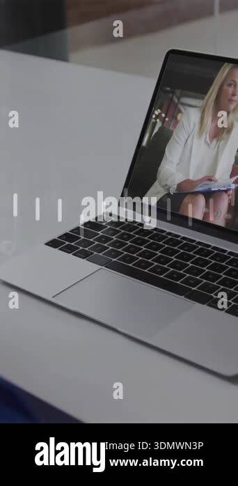 Discussing documents, business professionals on video call using laptop ...