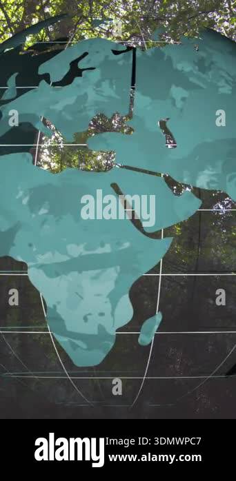Rotating globe animation over lush green forest background, focusing on ...