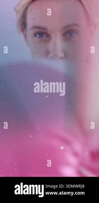 Wearing pink shirt, person creating animation with colorful, blurred ...