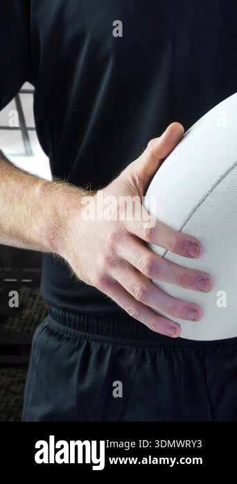 Animation of caucasian male rugby player holding ball over stadium ...