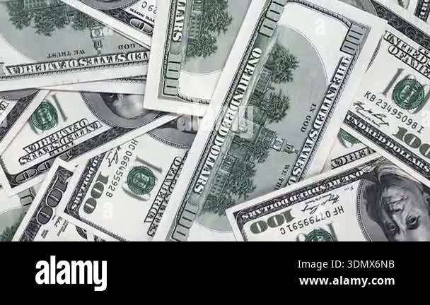 Cash is shown on a table in different arrangements. Each frame ...