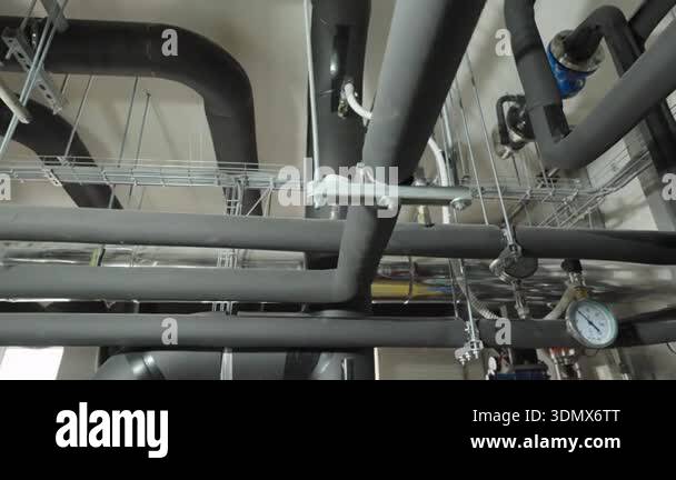 Complex network of industrial insulated pipes and metal support ...