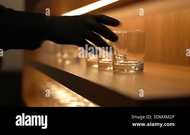 Gloved Hand Arranging Empty Glasses on Wooden Shelf Stock Video Footage ...