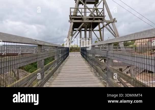 A steady walk along a wooden bridge leading to an observation tower ...