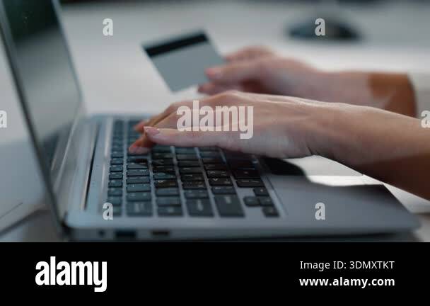Female hands typing laptop with bank credit card unrecognizable ...