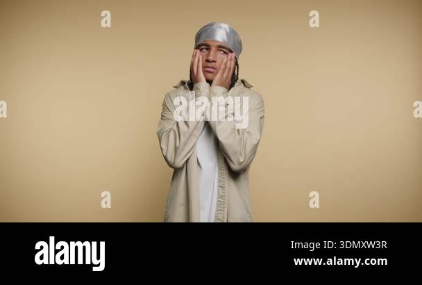 A young person expresses a range of emotions using facial gestures and ...