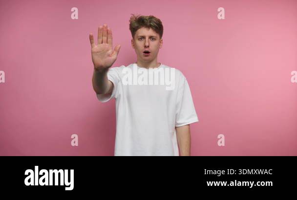 A person gestures with their hand to signal stop while showing various ...