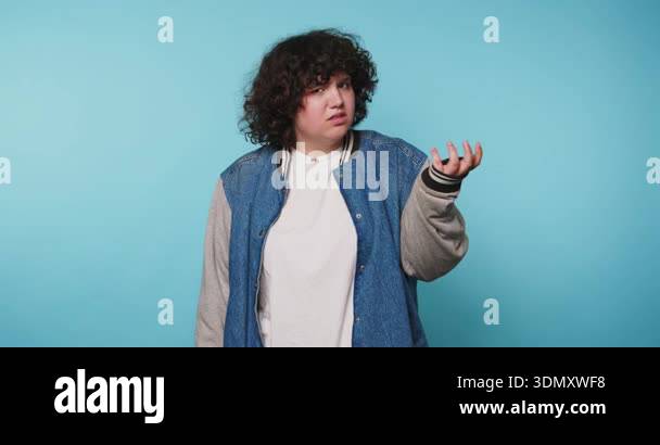 A person stands in front of a blue background showing different ...