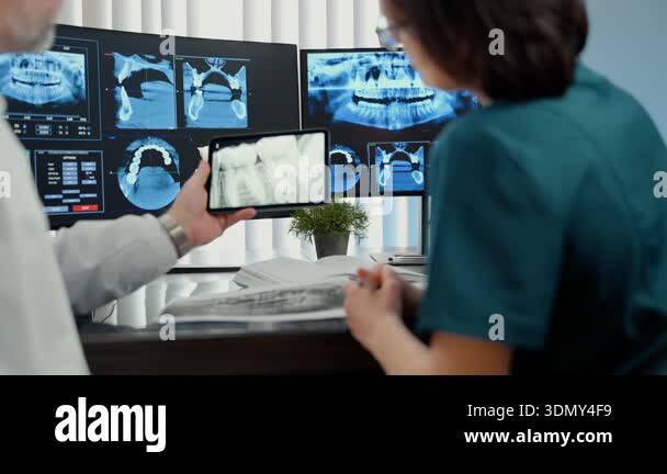 Doctors are analyzing teeth MRI CT scan image and multiple monitors ...