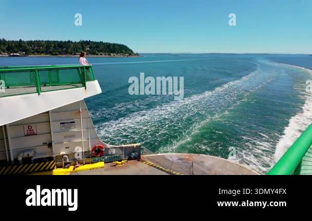 Wake of cruise ship. Boat creates foam on water surface. Back view of ...