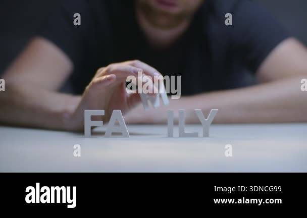 Male hands composition word family from white letters on gray ...