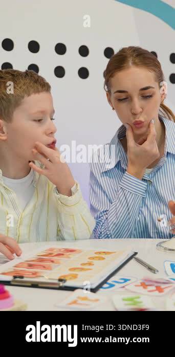 Dedicated speech language pathologist working with a little boy in a ...