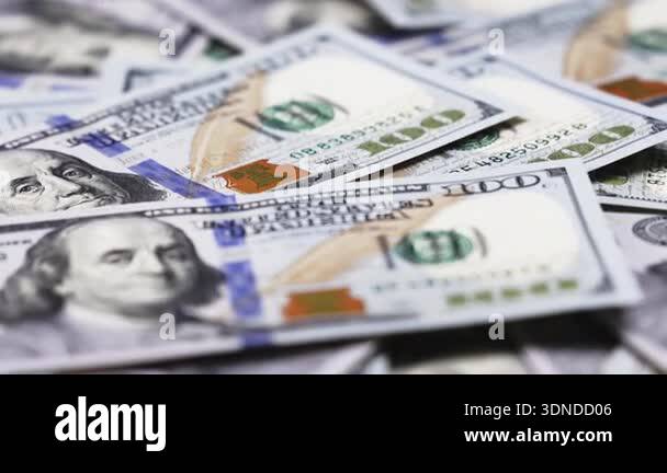 Neatly arranged stack of hundred dollar bills on a black background ...