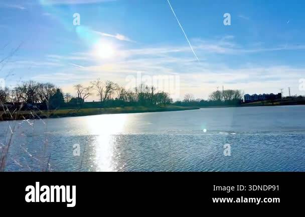 Partially frozen lake with melting ice in spring. Transition from ...