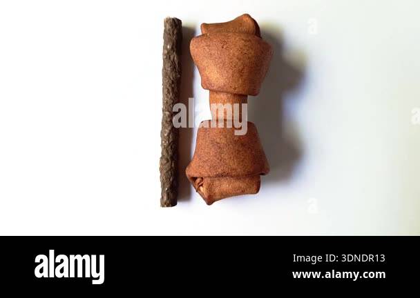 Rawhide dog bone and dental chew stick isolated on a white background ...