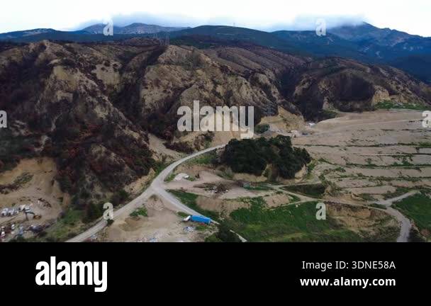 A mountain excavation zone with stepped quarry levels, burned ...