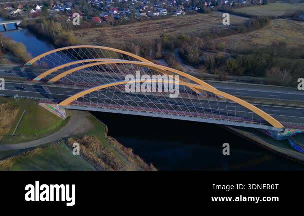 Highway arch bridge carrying cars across a river, connecting ...