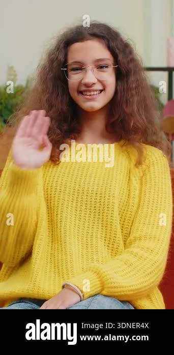 Young child girl smiling friendly at camera and waving hands gesturing ...