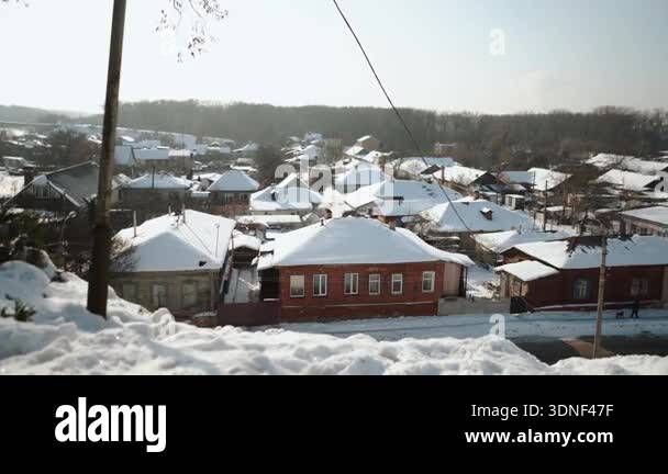 A frosty, cold day in the city in winter. Houses are heated by smoke ...
