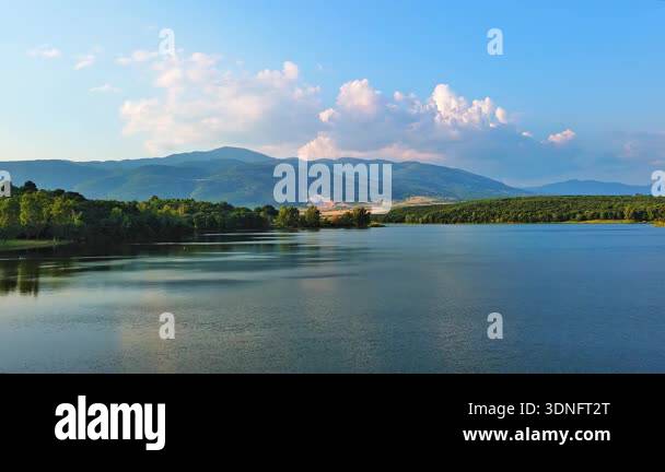 Small blue reflecting lake and clear cool water with stone narrow wild ...