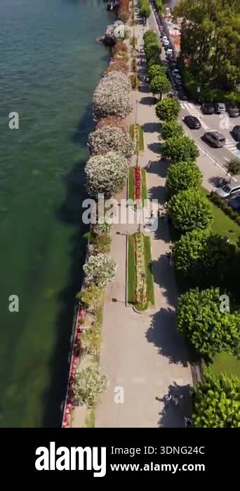 Aerial view of a picturesque lakeside walkway in Italy, showcasing ...