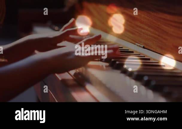 Child hovering fingers above piano keys and starting soft melody ...