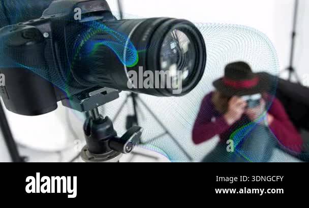Photographer crouching behind DSLR on tripod, raising film camera ...