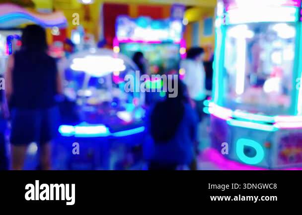 Blurred background of vibrant arcade scene filled with colorful games ...