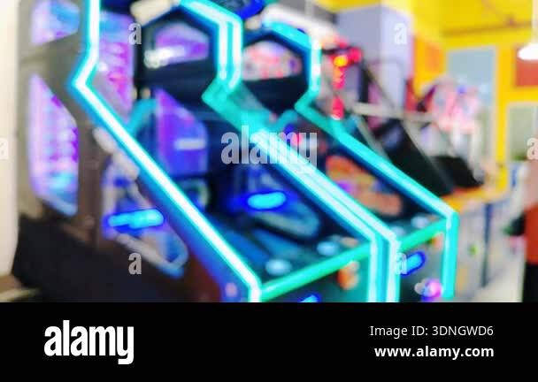 Blurred view of a bustling game room filled with people enjoying ...