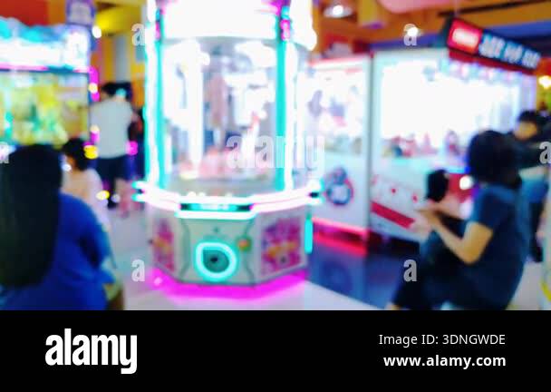 Blurred background of vibrant arcade scene filled with colorful games ...