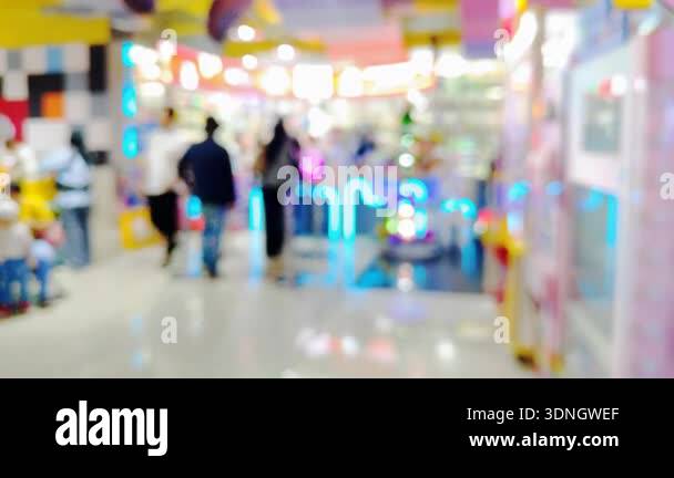 Blurred background of vibrant arcade scene filled with colorful games ...