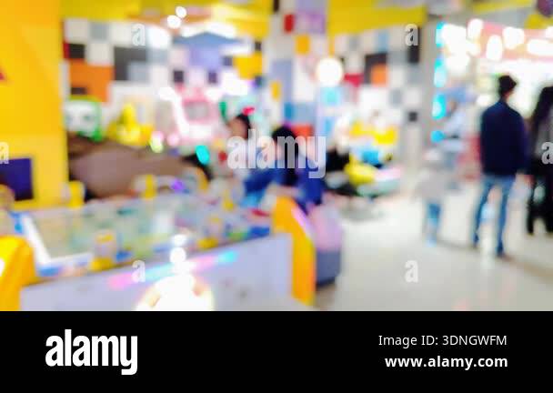 Blurred background of vibrant arcade scene filled with colorful games ...