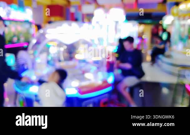 Blurred background of vibrant arcade scene filled with colorful games ...
