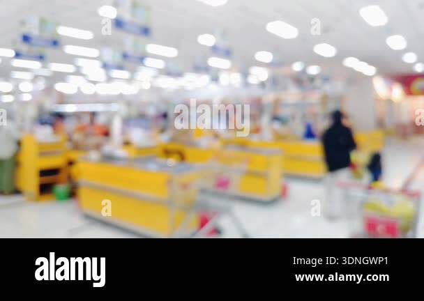 Busy shopping environment showing blurred of customers at cashier ...