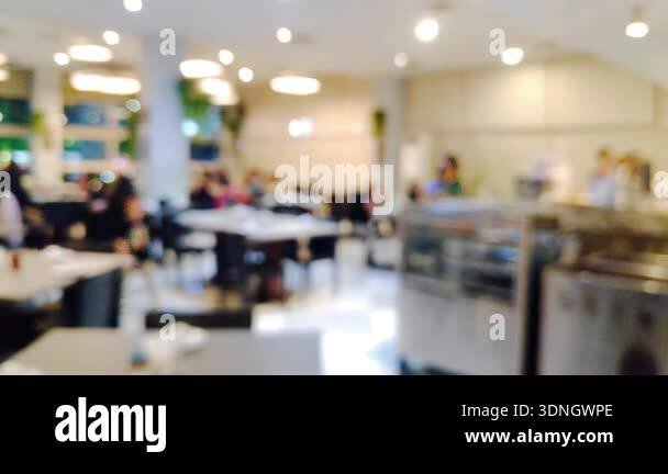 Busy restaurant scene featuring blurred of people eating with family ...