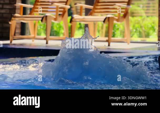 Water spouts with heavy bubbles in swimming pool slow motion. Relaxing ...