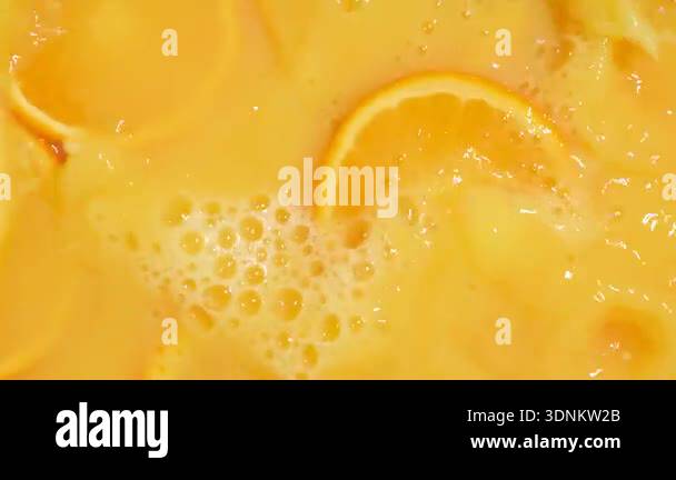 Refreshing orange juice explosion with falling fruit slices Stock Video ...