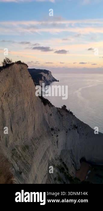 Cliffs overlooking calm water during sunset Stock Video Footage - Alamy