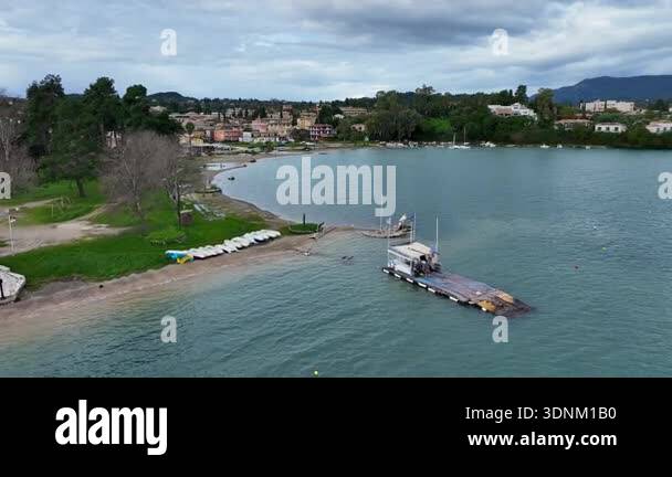 Aerial View of Small Wooden Pier with Greek Flag and Sailing Boats on ...