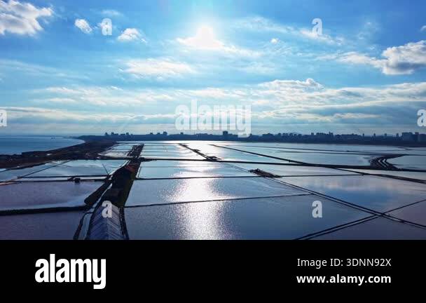 Bright sunlight dances on the surface of expansive salt flats, casting ...