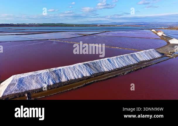 Salt flats stretch across the horizon, showcasing glistening pools of ...